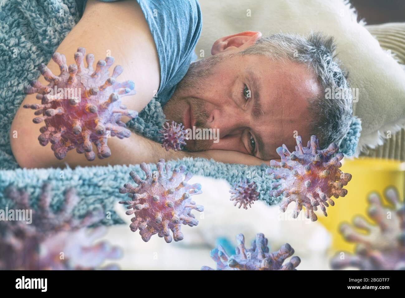 Man suffering from viral disease lies sadly covered with a blanket on ...