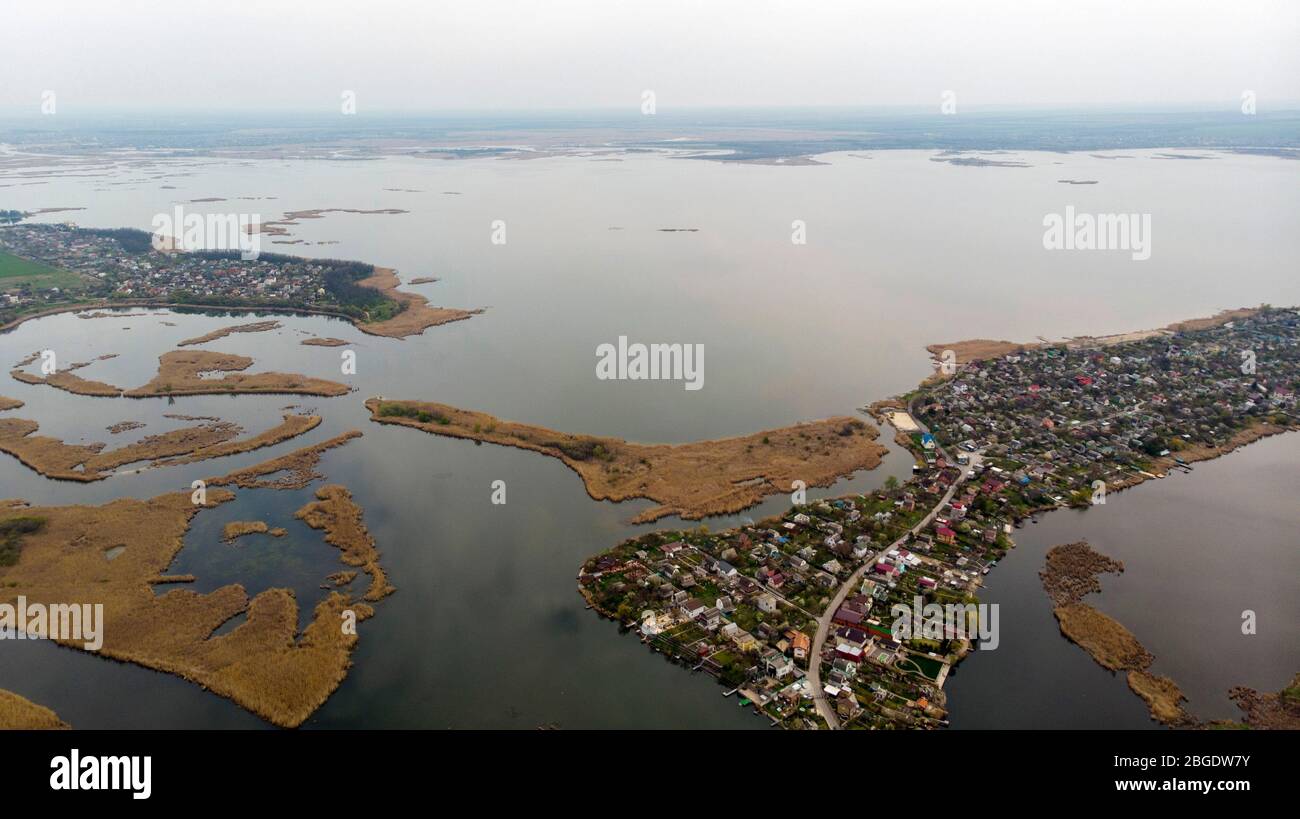 Bird's-eye view to the village, streets, roads, islands and river delta ...
