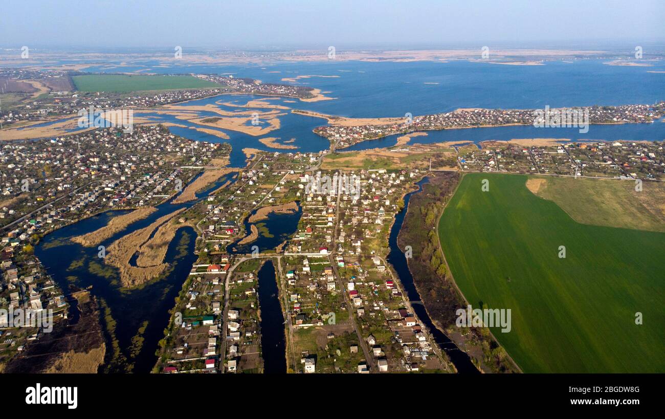 Bird's-eye view to the village, streets, roads, islands and river delta ...