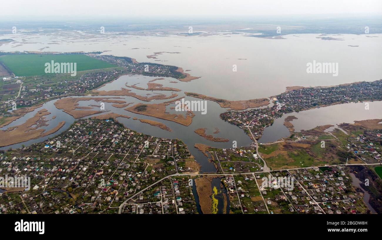 Bird's-eye view to the village, streets, roads, islands and river delta ...