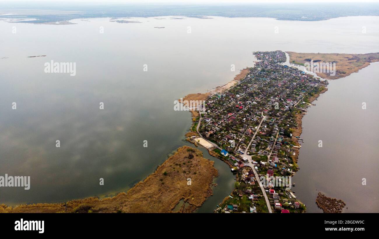 Bird's-eye view to the village, streets, roads, islands and river delta ...