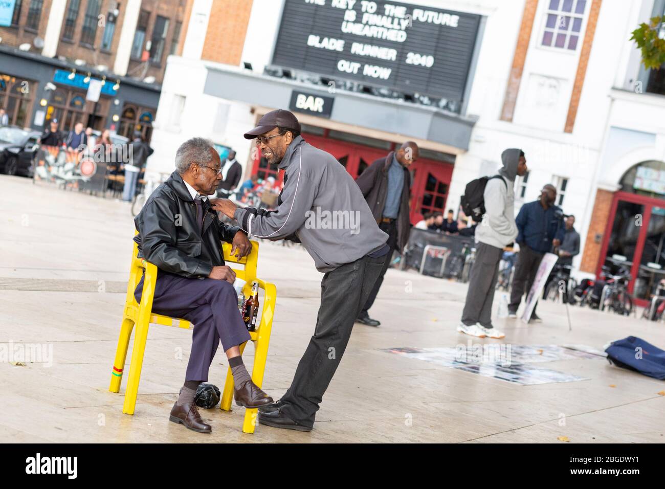 Two men chatting in Windrush Square, Brixton, London Stock Photo - Alamy