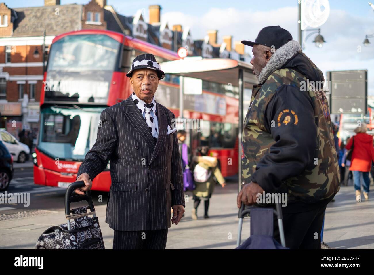 Two men standing on Brixton Road with a bus in the background, London ...
