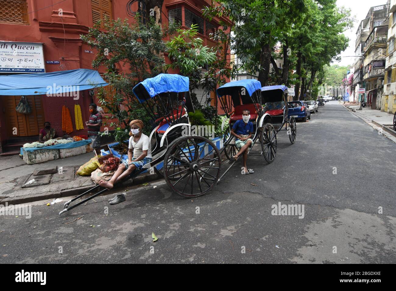 Kolkata, India. 21st Apr, 2020. Hand pulled rickshaws are waiting for ...