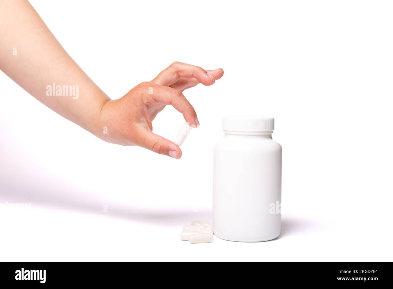 Child hand taking tablet from medicine comtainer, isolated on a white ...