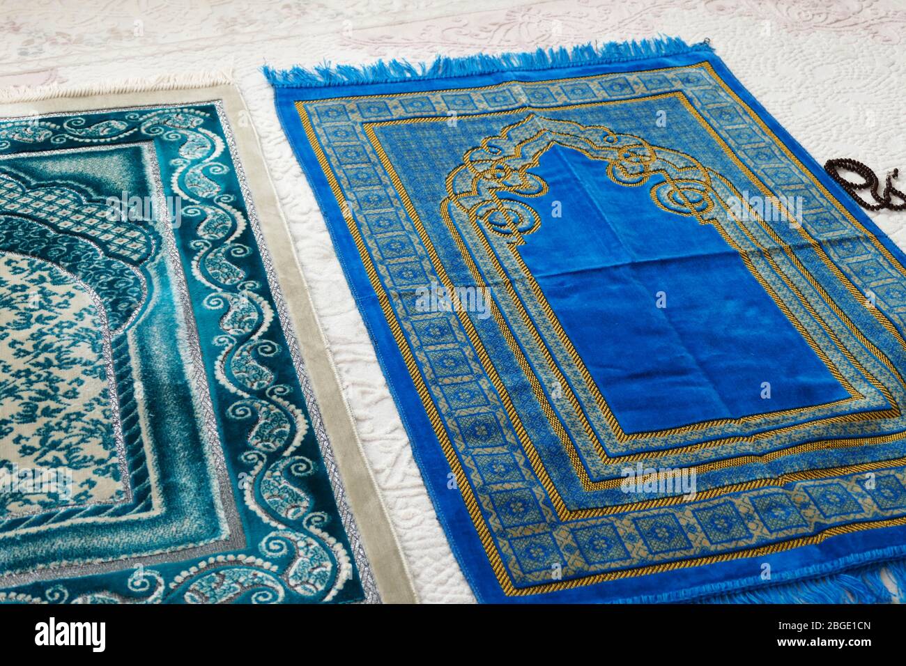 Islamic symbols, prayer rugs on a carpet in a house Stock Photo - Alamy