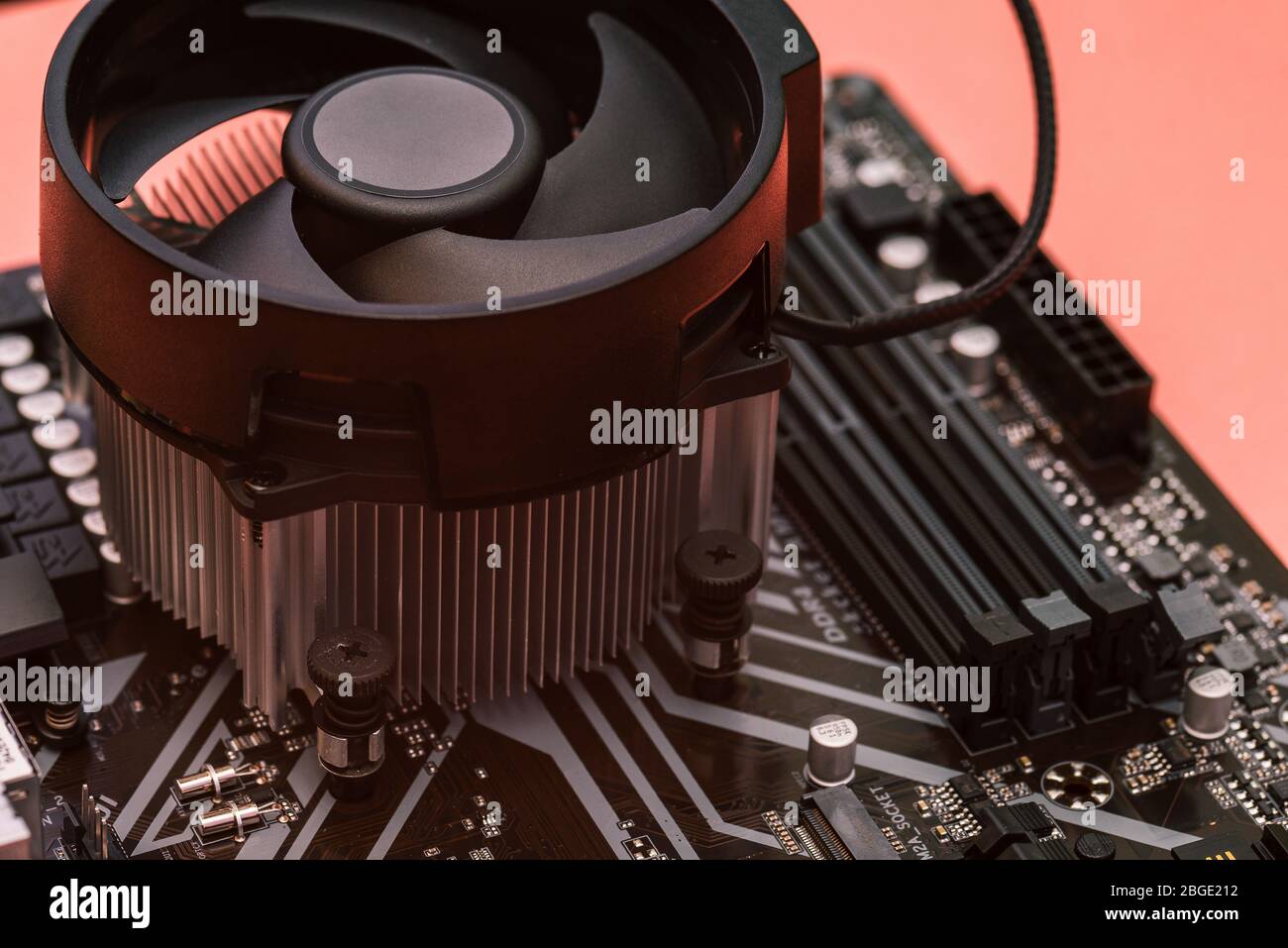 Cooler with a fan is installed on a computer motherboard. The cooling ...