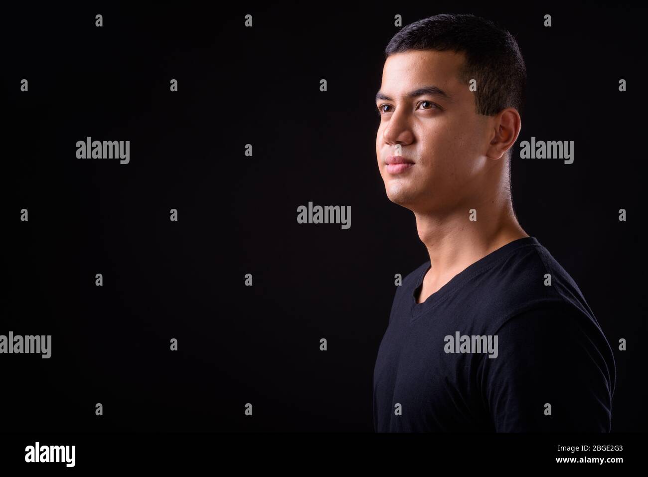 Profile view of young handsome Asian man looking up Stock Photo - Alamy