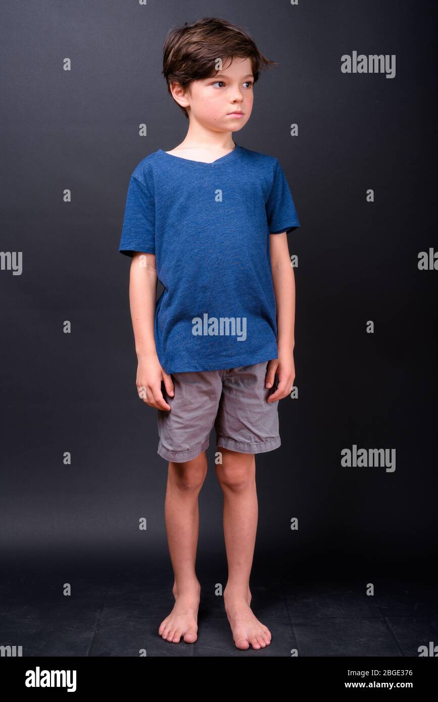 Full body shot of young handsome boy thinking Stock Photo - Alamy