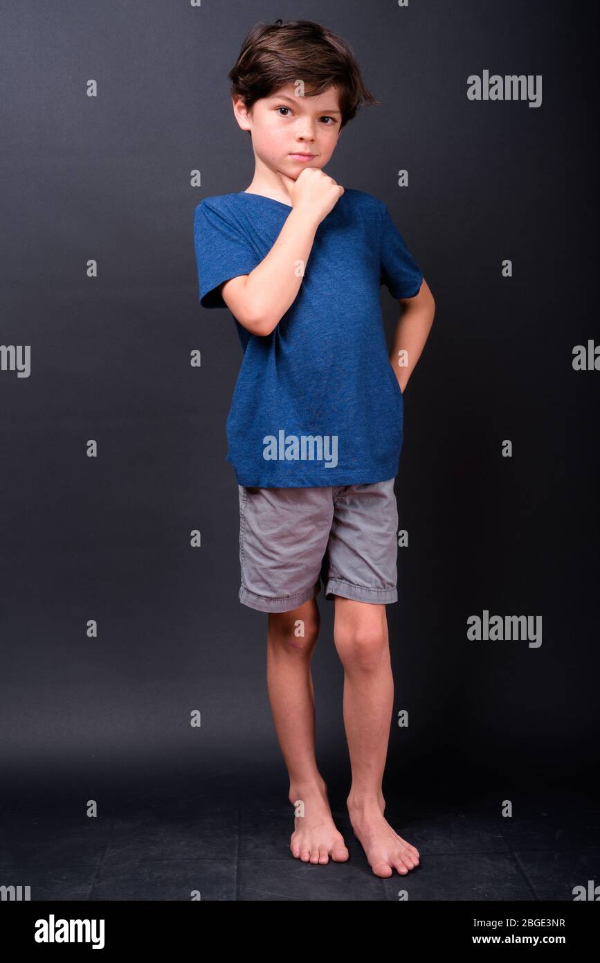 Full body shot of young handsome boy thinking Stock Photo - Alamy
