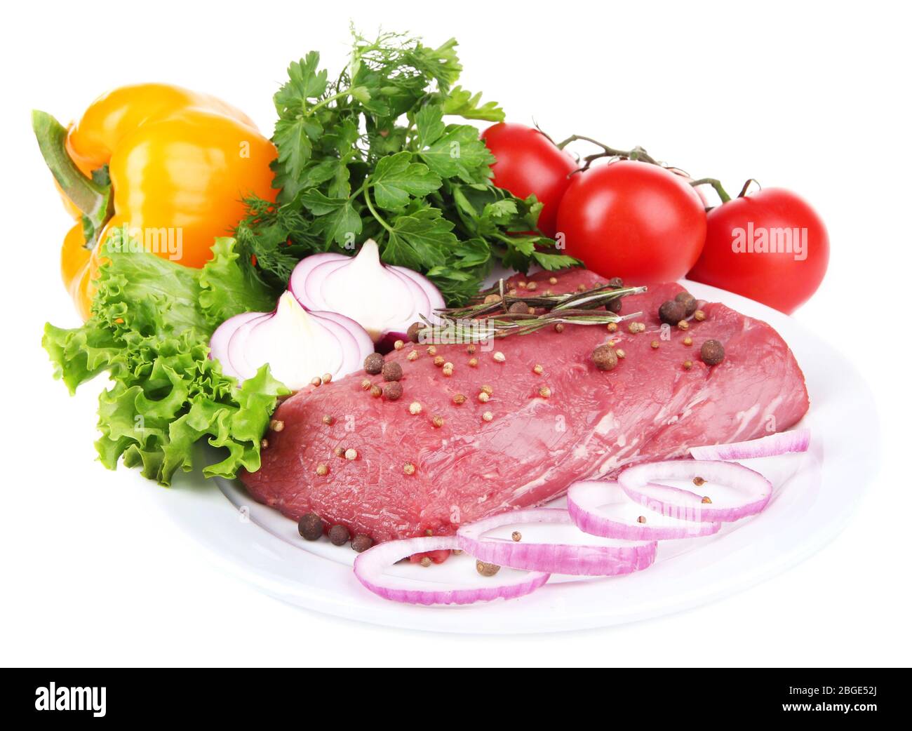 Raw beef meat with vegetables on plate isolated on white Stock Photo ...