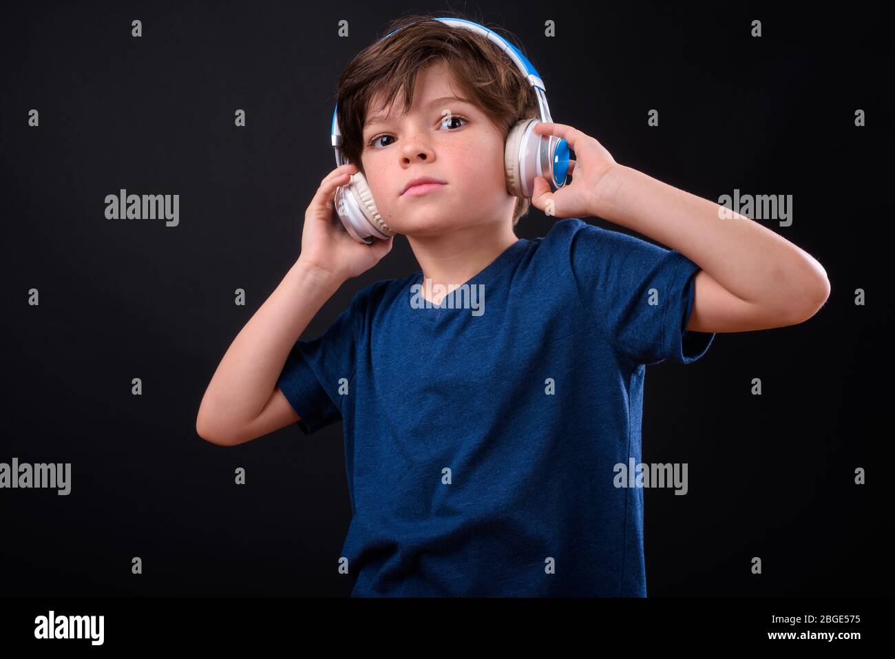 Portrait of young handsome boy listening to music Stock Photo - Alamy