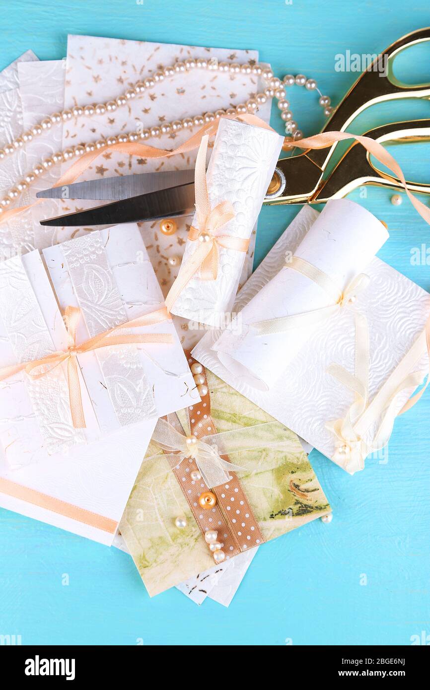 Beautiful handmade wedding cards on blue background Stock Photo - Alamy