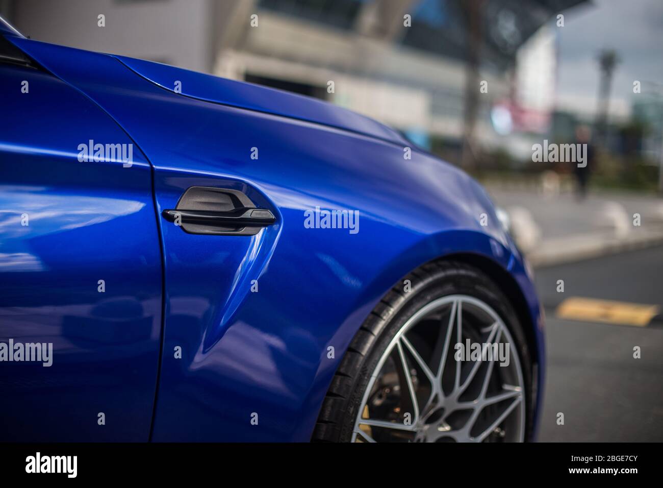 Front black wheel of a blue sport car Stock Photo - Alamy