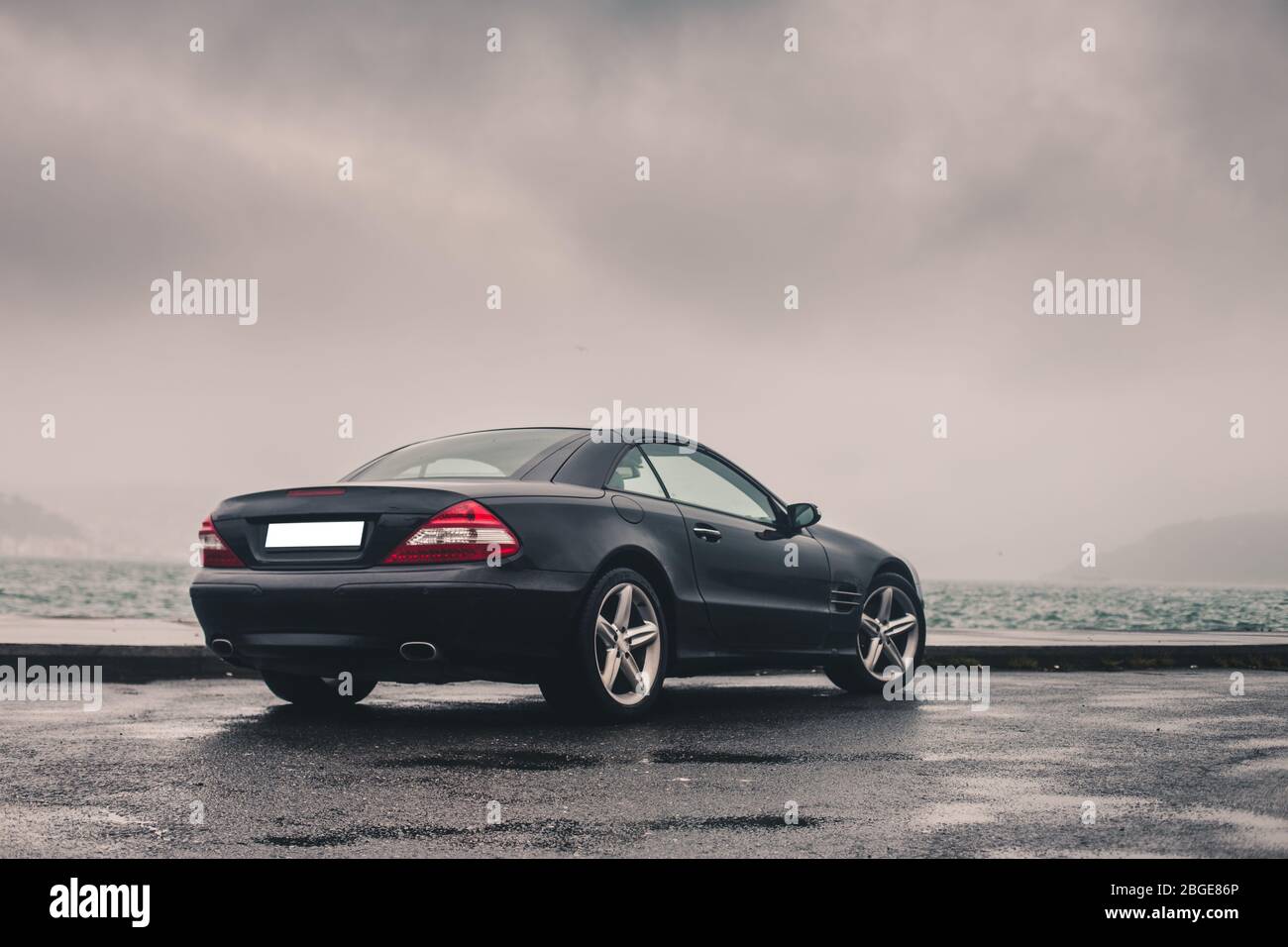 Black old model sedan at the beach in the fog Stock Photo - Alamy