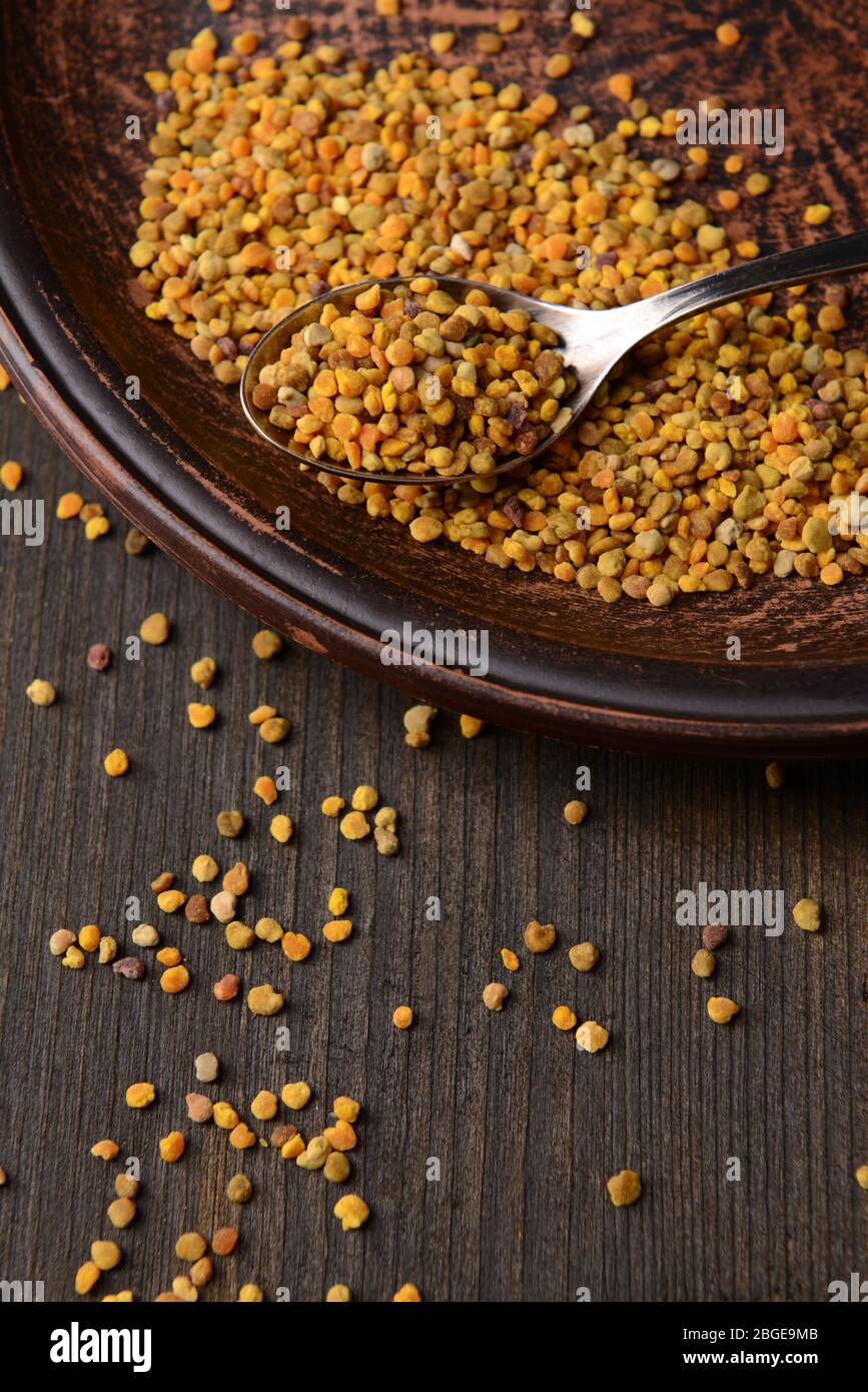 Spice pollen in spoon on wooden background Stock Photo - Alamy