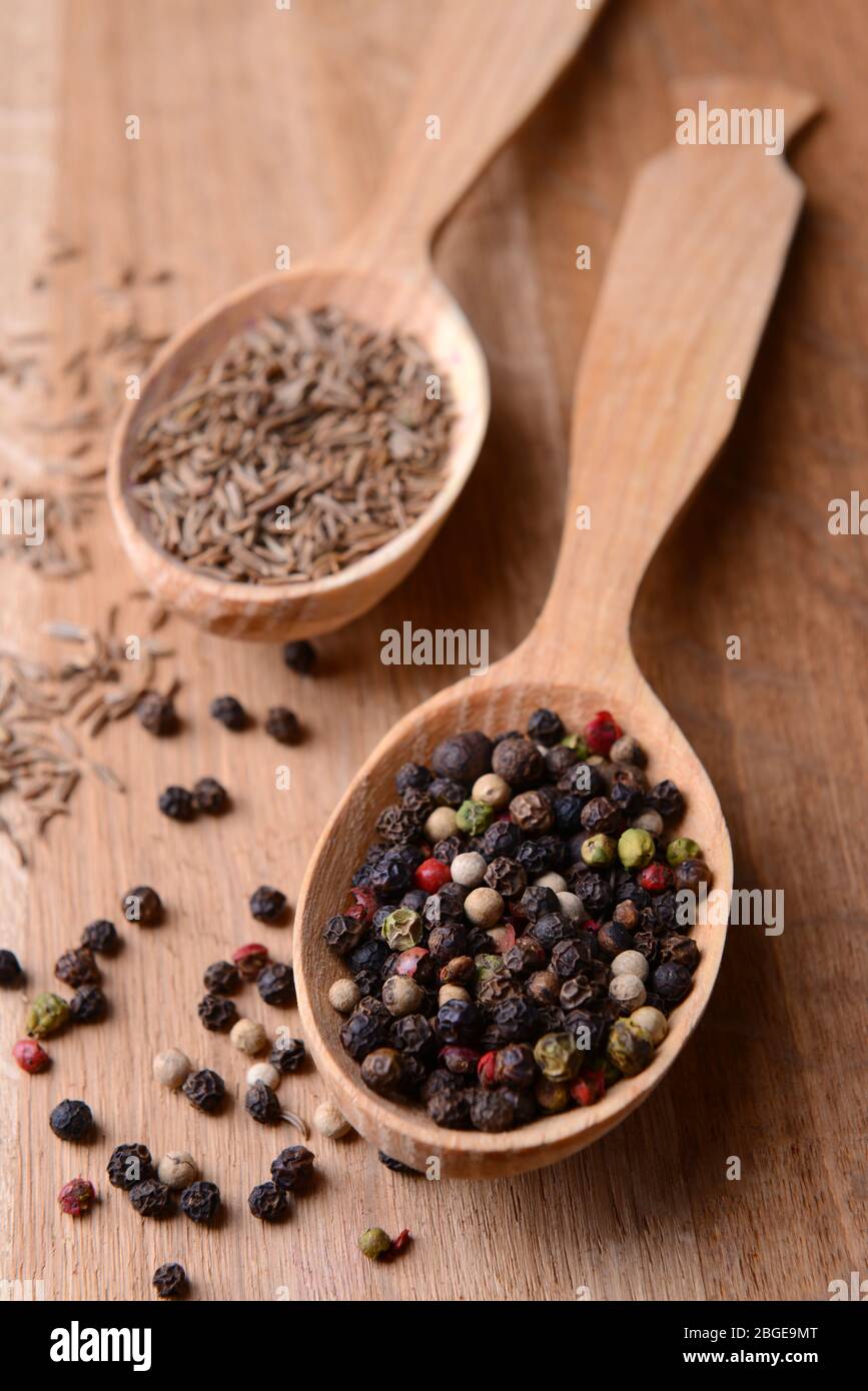 Different spices in spoons on wooden background Stock Photo - Alamy