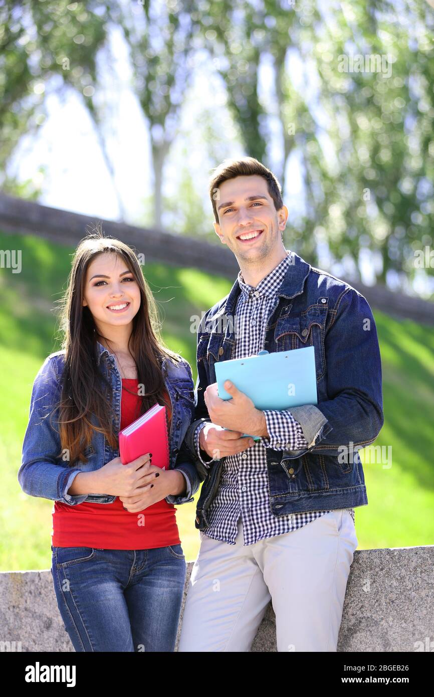 Happy students in park Stock Photo - Alamy