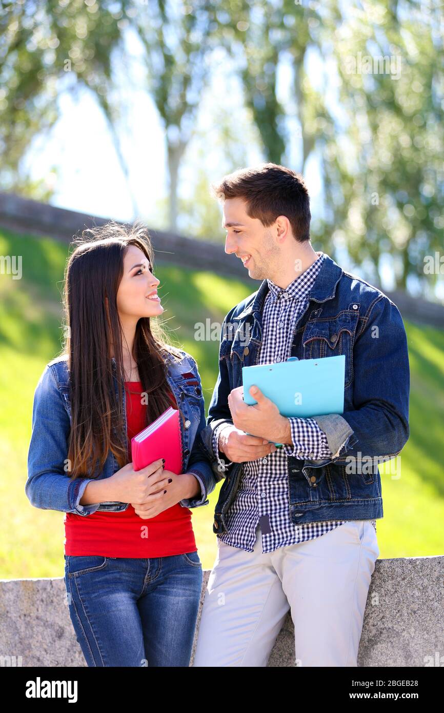 Happy students in park Stock Photo - Alamy
