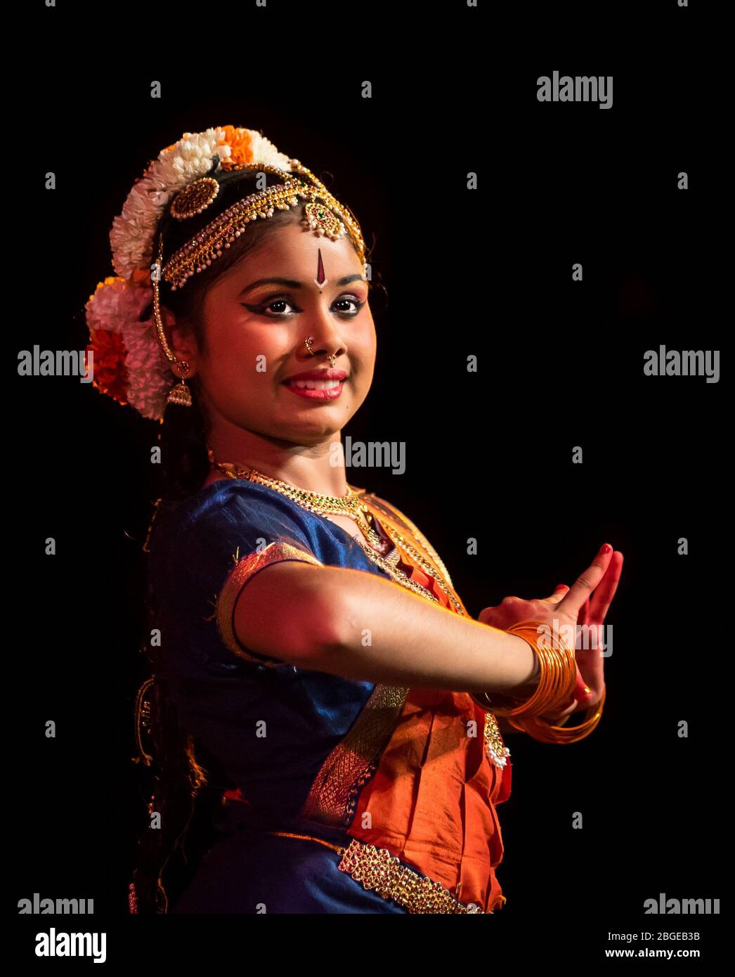 A beautiful and colorfully dressed Bharathanatyam dancer performing at ...