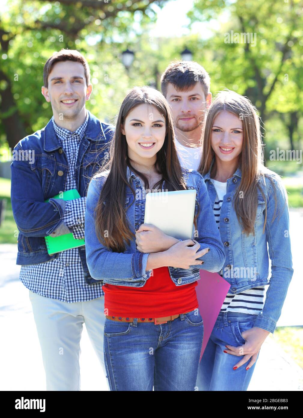 Happy students in park Stock Photo - Alamy