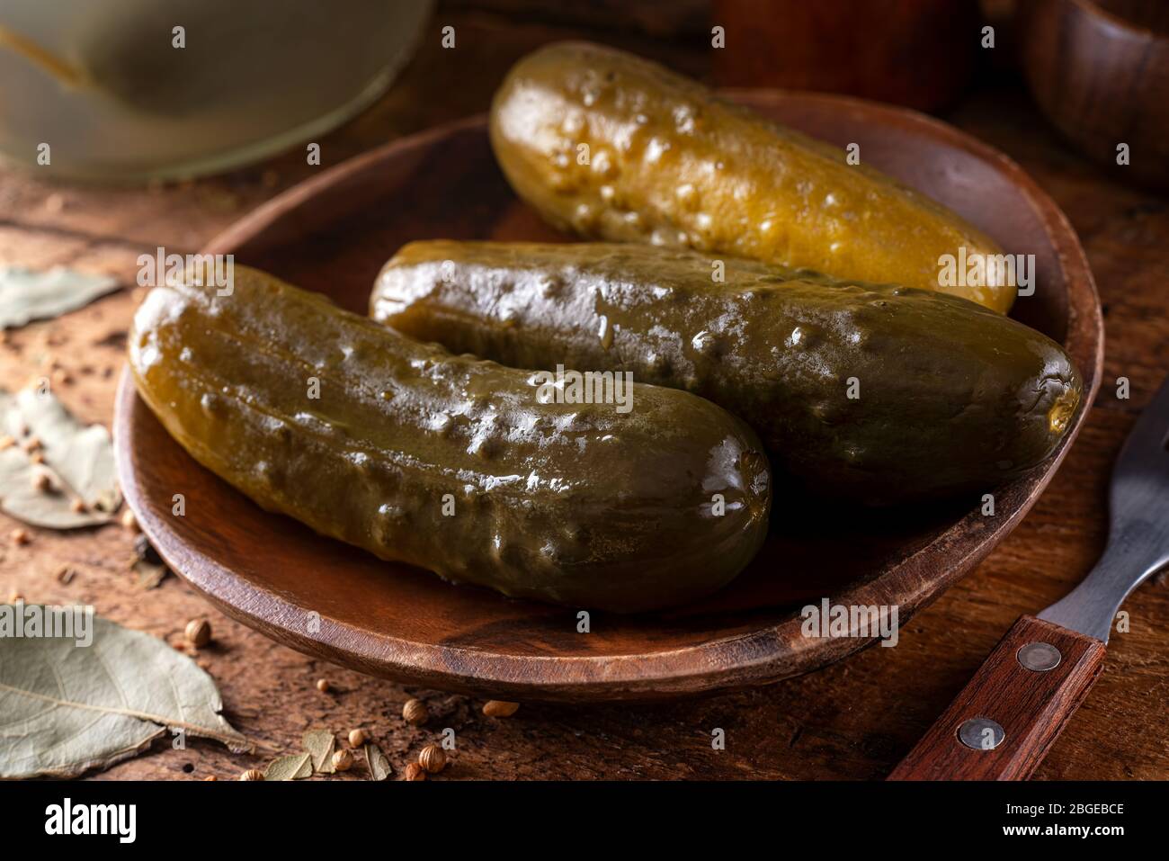 Delicious naturally fermented kosher dill pickles on a rustic table top ...
