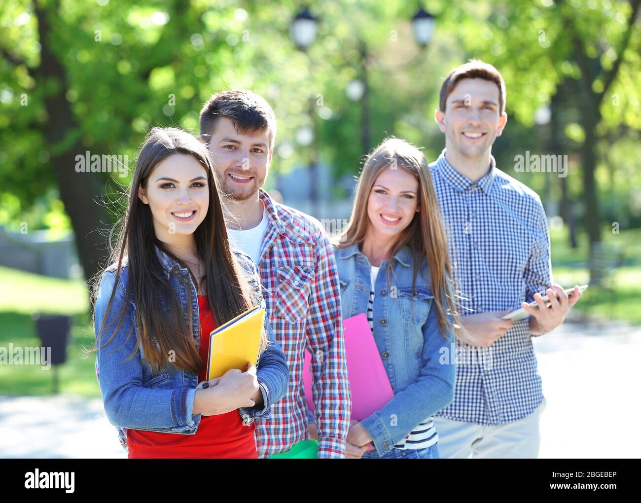 Happy students in park Stock Photo - Alamy