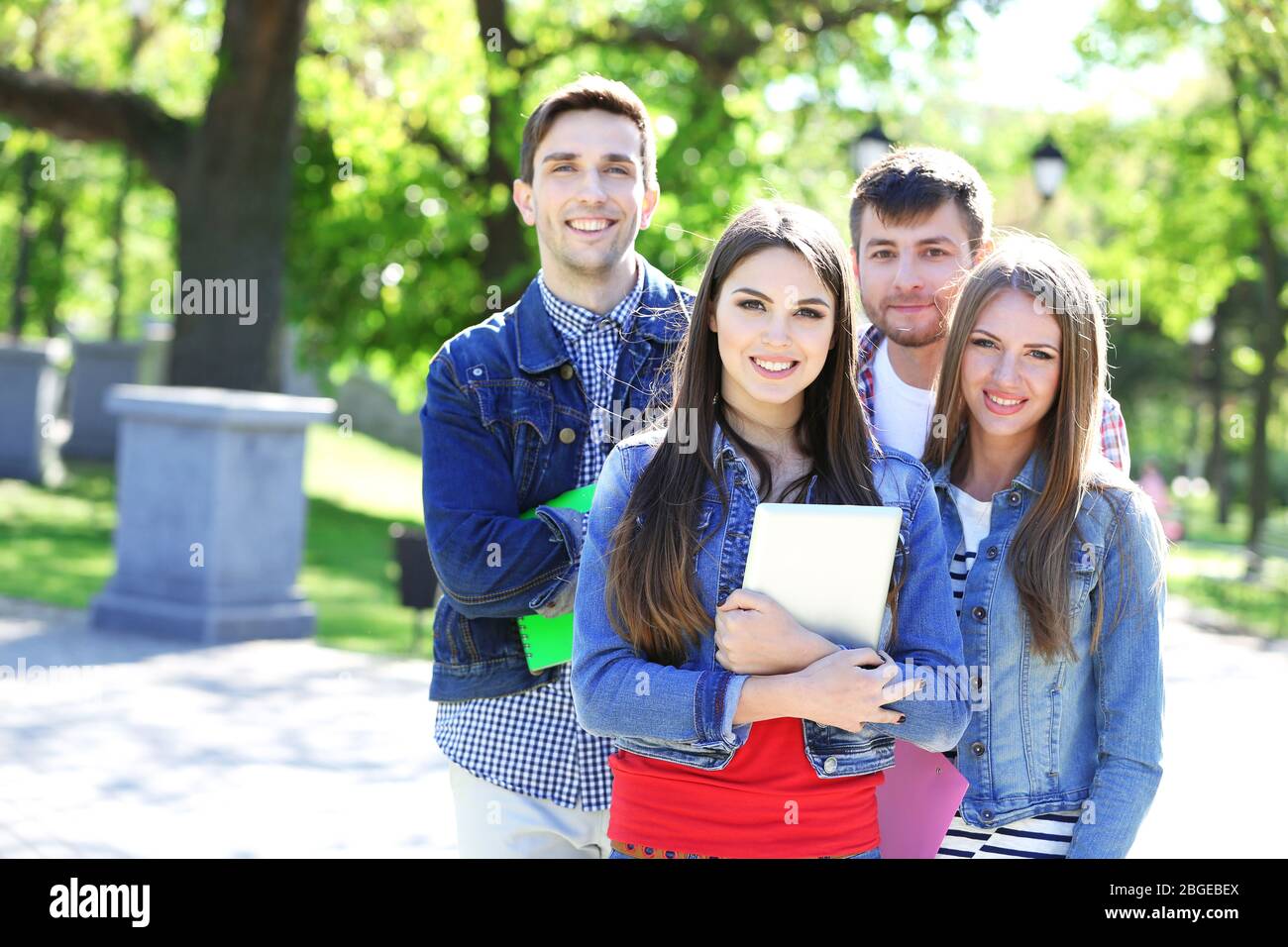 Happy students in park Stock Photo - Alamy