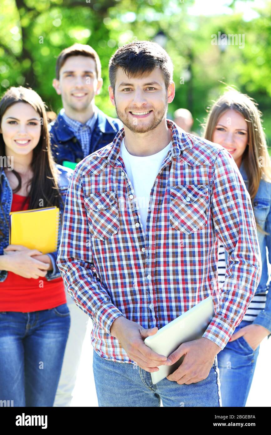 Happy students in park Stock Photo - Alamy