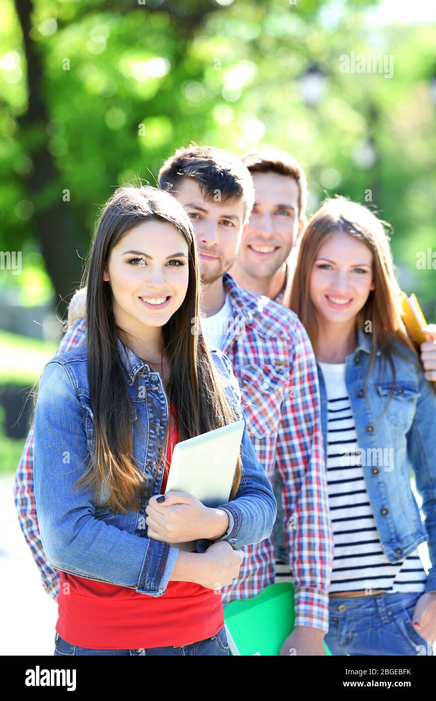 Happy students in park Stock Photo - Alamy
