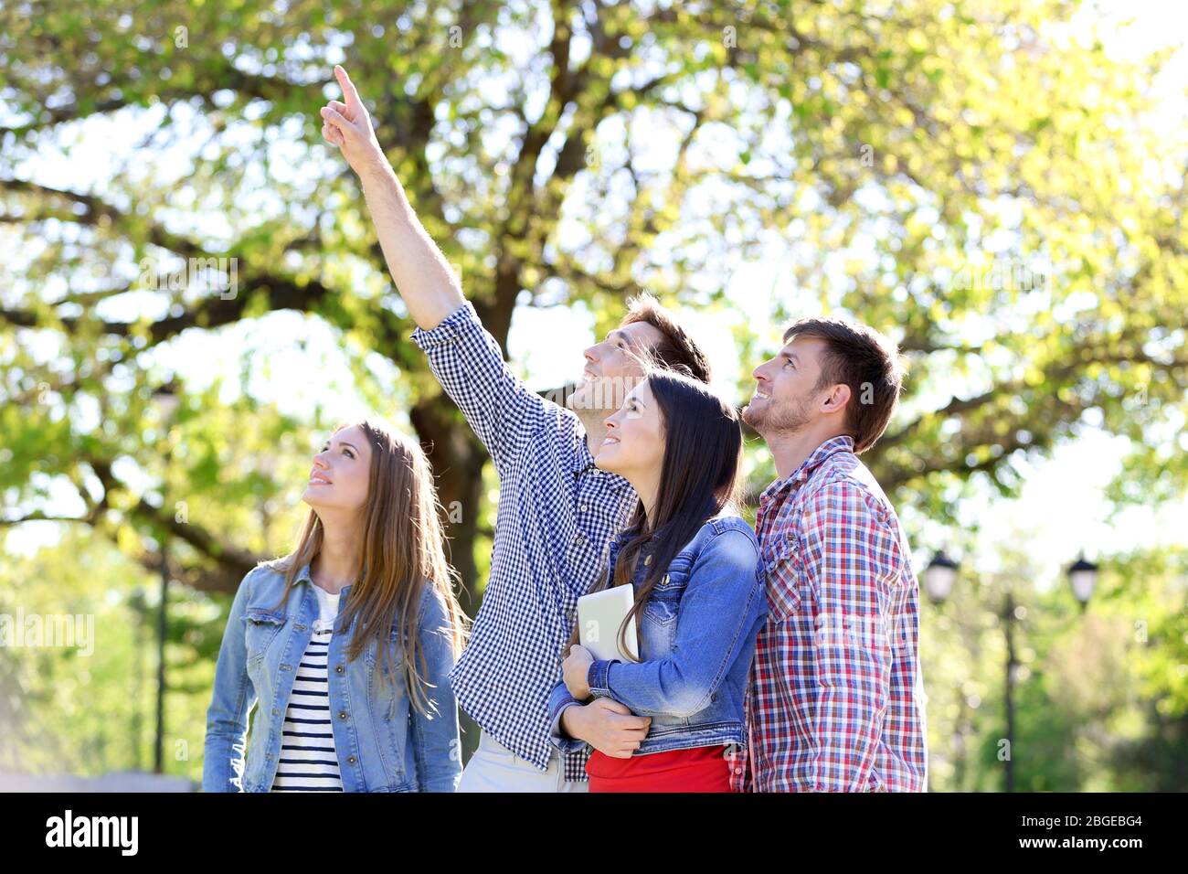 Happy students in park Stock Photo - Alamy