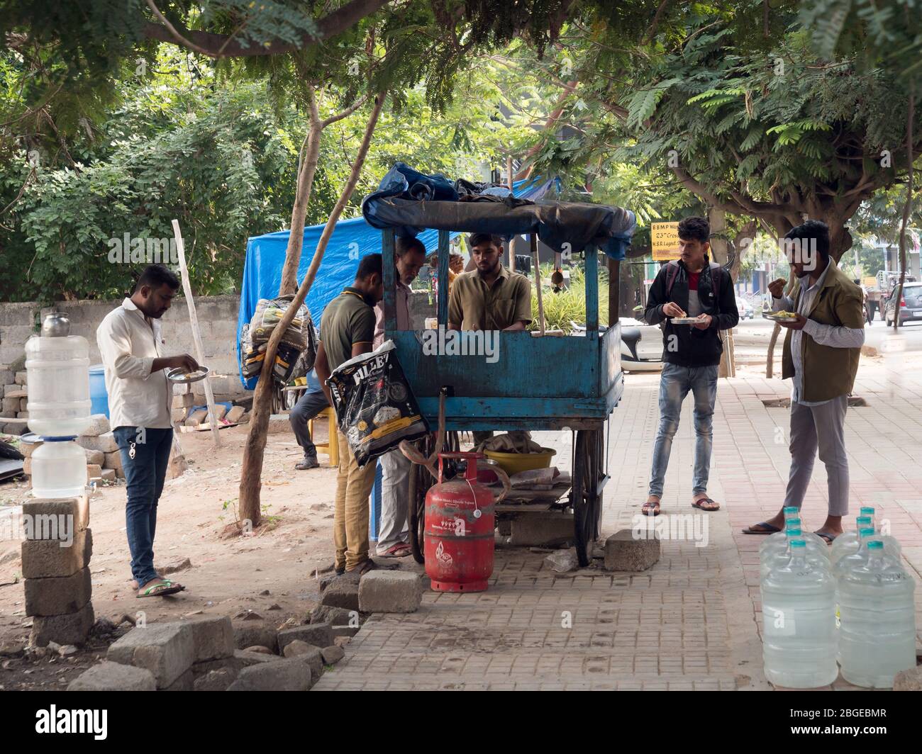 People eating at a road side makeshift eatery during day time Stock ...