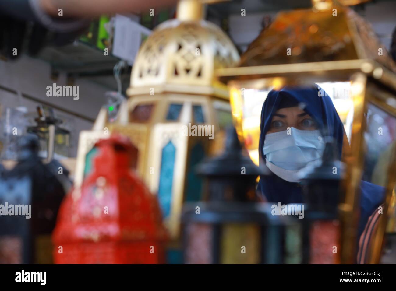 Baghdad, Iraq. 21st Apr, 2020. A woman wearing a face mask shops for ...