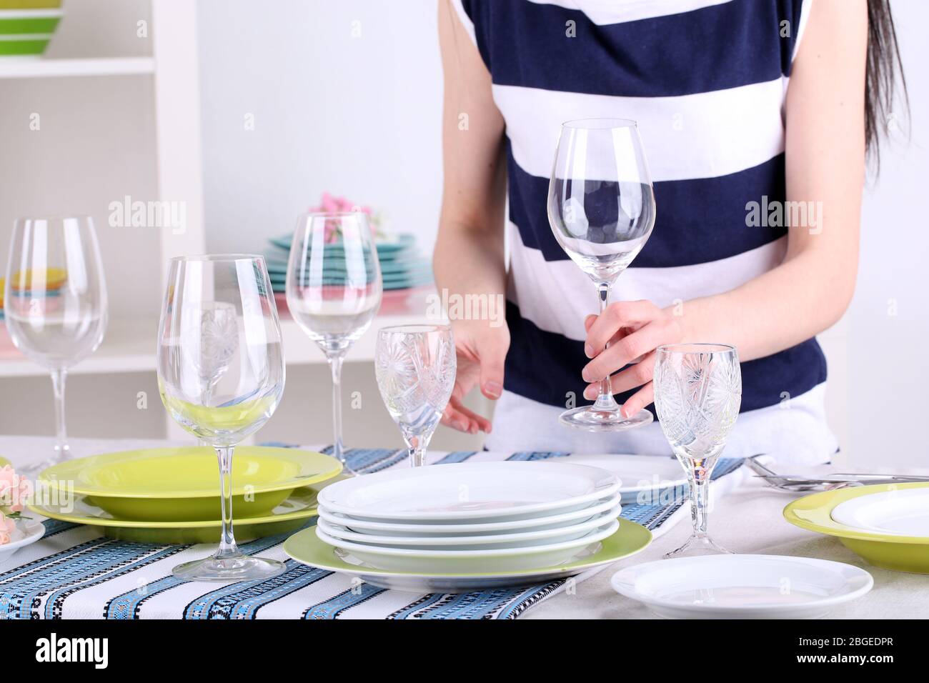 Woman laying table in room Stock Photo - Alamy
