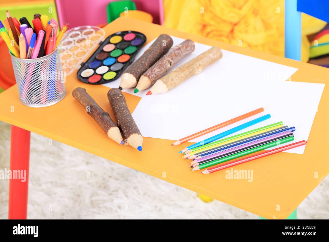 Interior of classroom at school. Crayons and paper on table Stock Photo ...