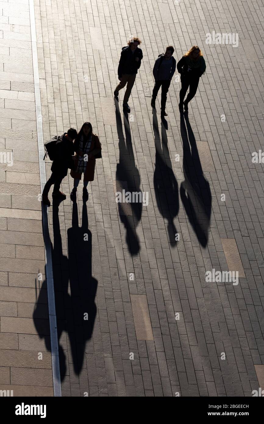 People casting long shadows outside the Southbank Centre, South Bank ...
