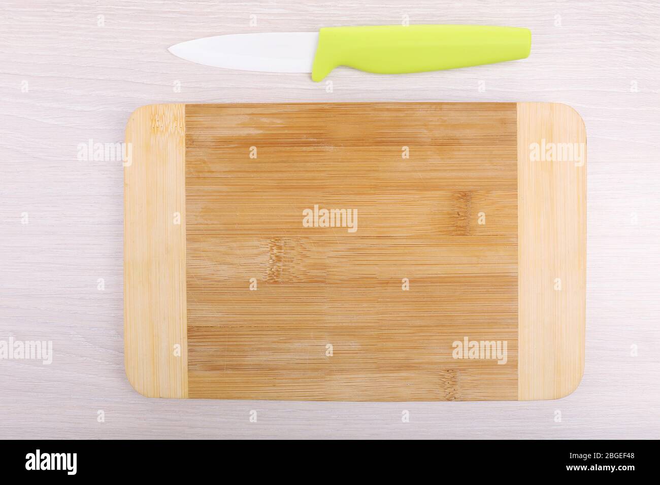 Kitchen knife and cutting board on wooden table Stock Photo - Alamy