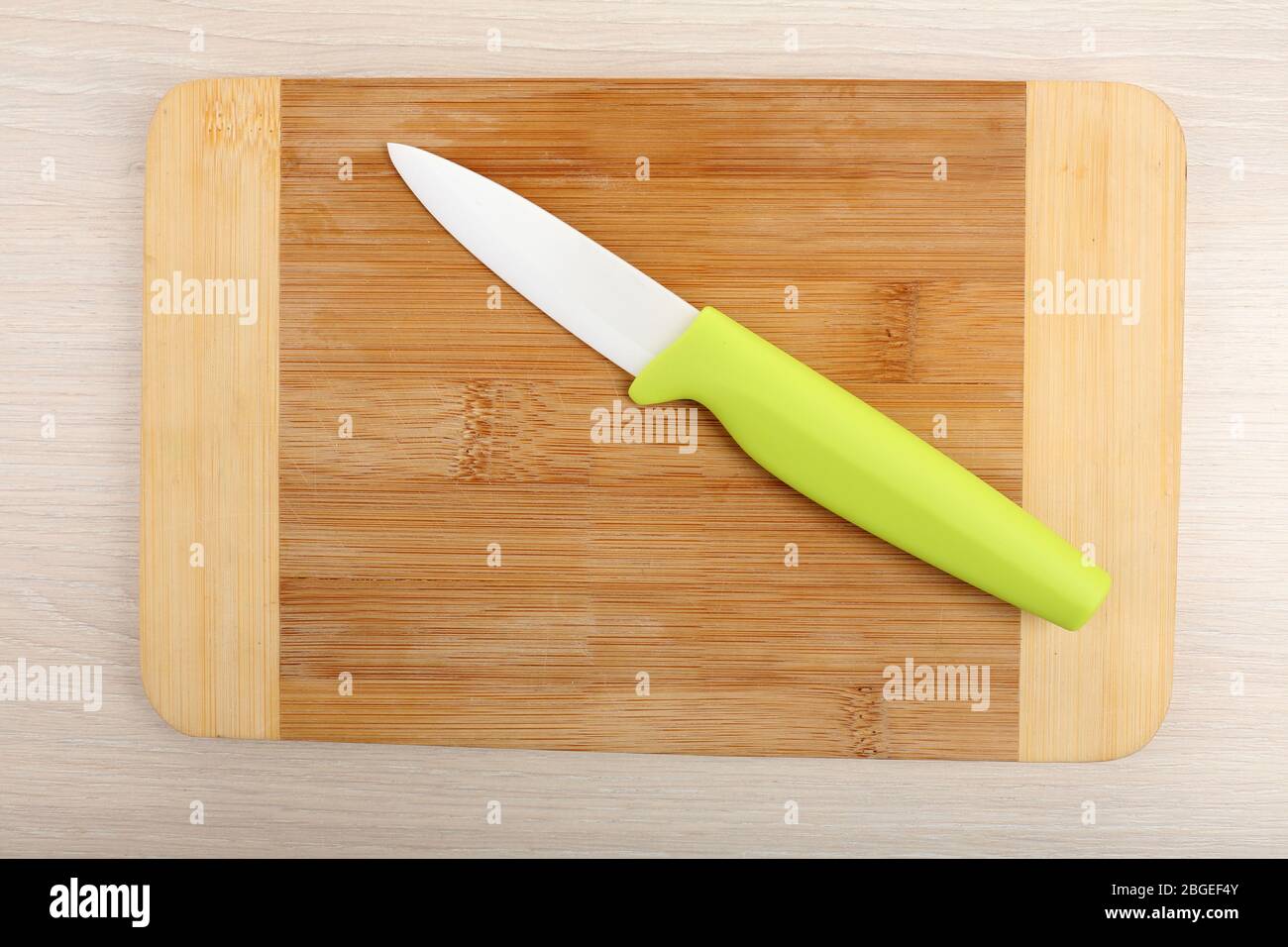 Kitchen knife and cutting board on wooden table Stock Photo - Alamy