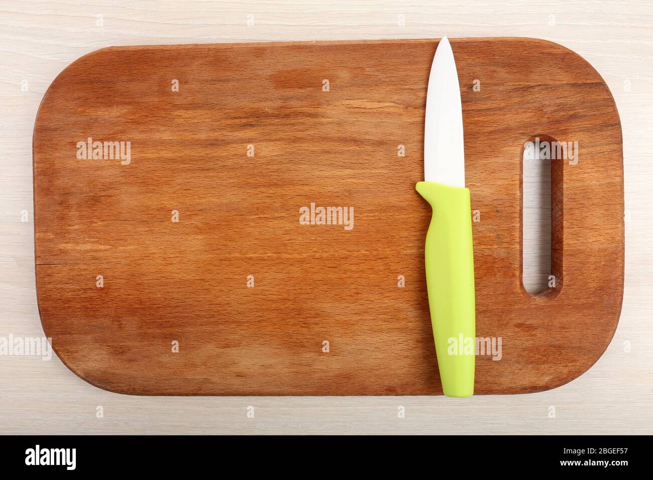 Kitchen knife and cutting board on wooden table Stock Photo - Alamy