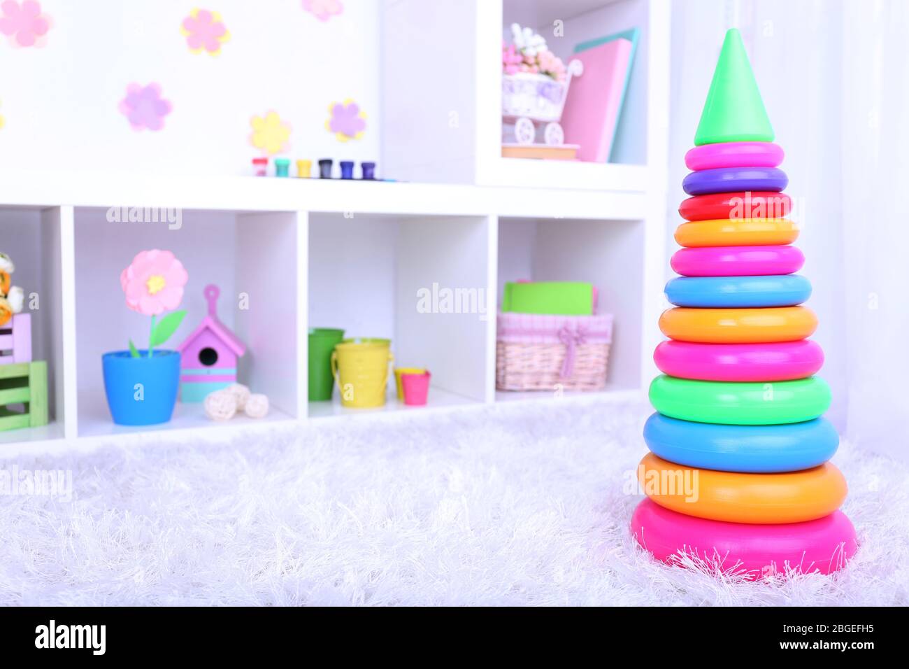 Plastic toy pyramid in children room Stock Photo - Alamy