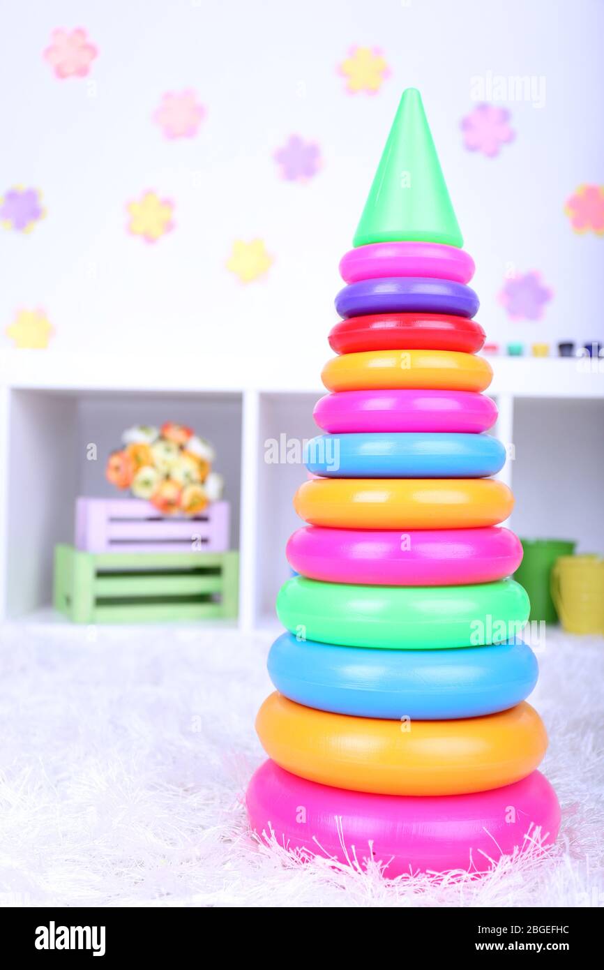 Plastic toy pyramid in children room Stock Photo - Alamy
