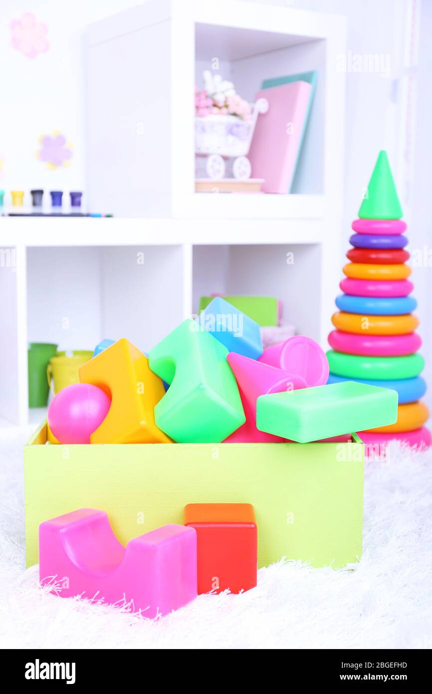 Colorful plastic toys in children room Stock Photo - Alamy