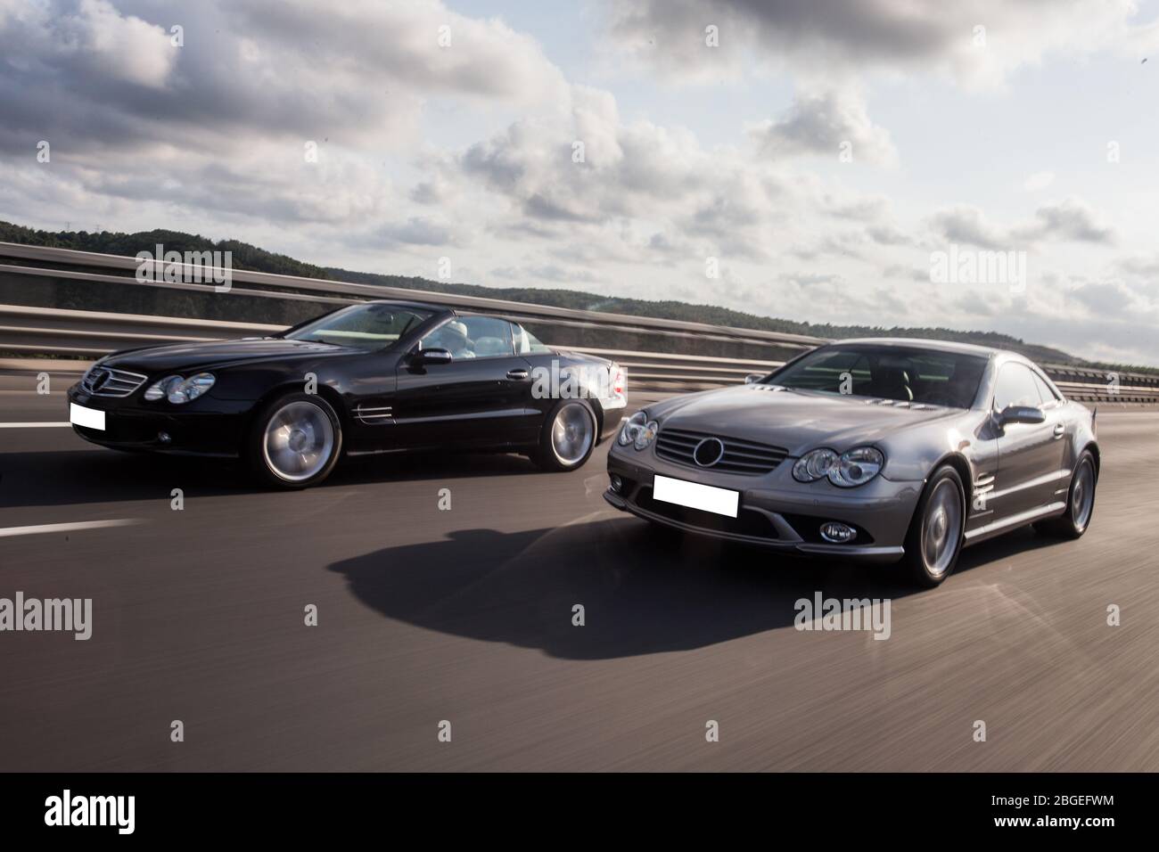 Black car chasing on street hi-res stock photography and images - Alamy