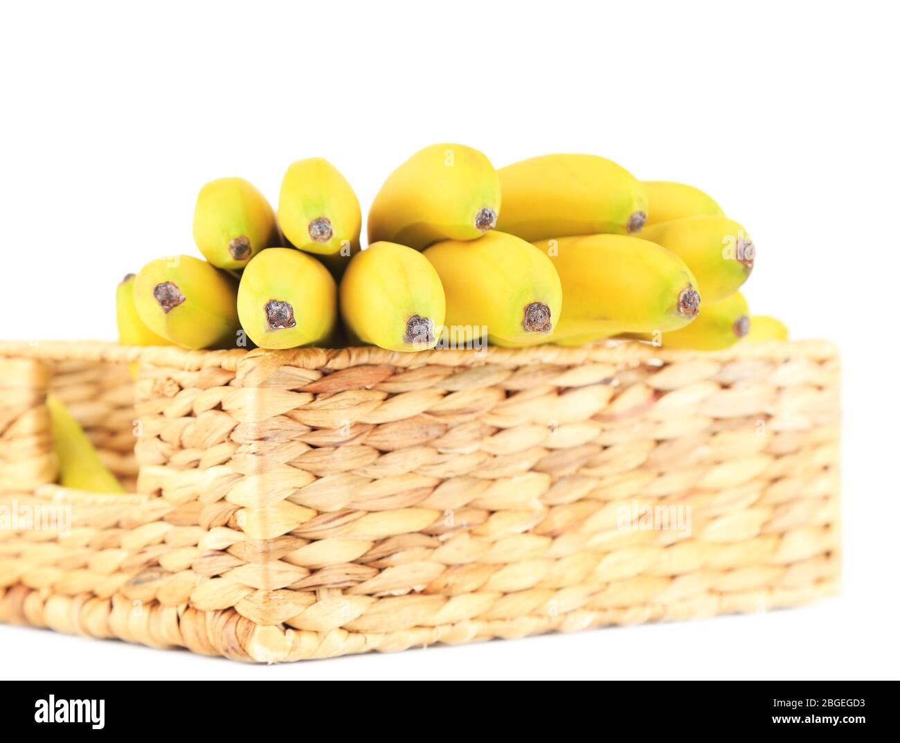 Bunch of mini bananas in wicker basket isolated on white Stock Photo ...