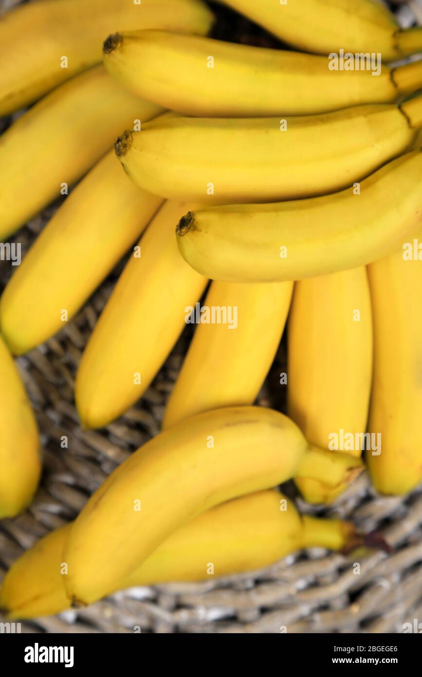 Bunch of mini bananas on wicker mat background Stock Photo - Alamy