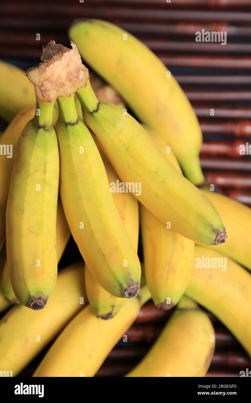 Bunch of mini bananas on bamboo mat background Stock Photo - Alamy