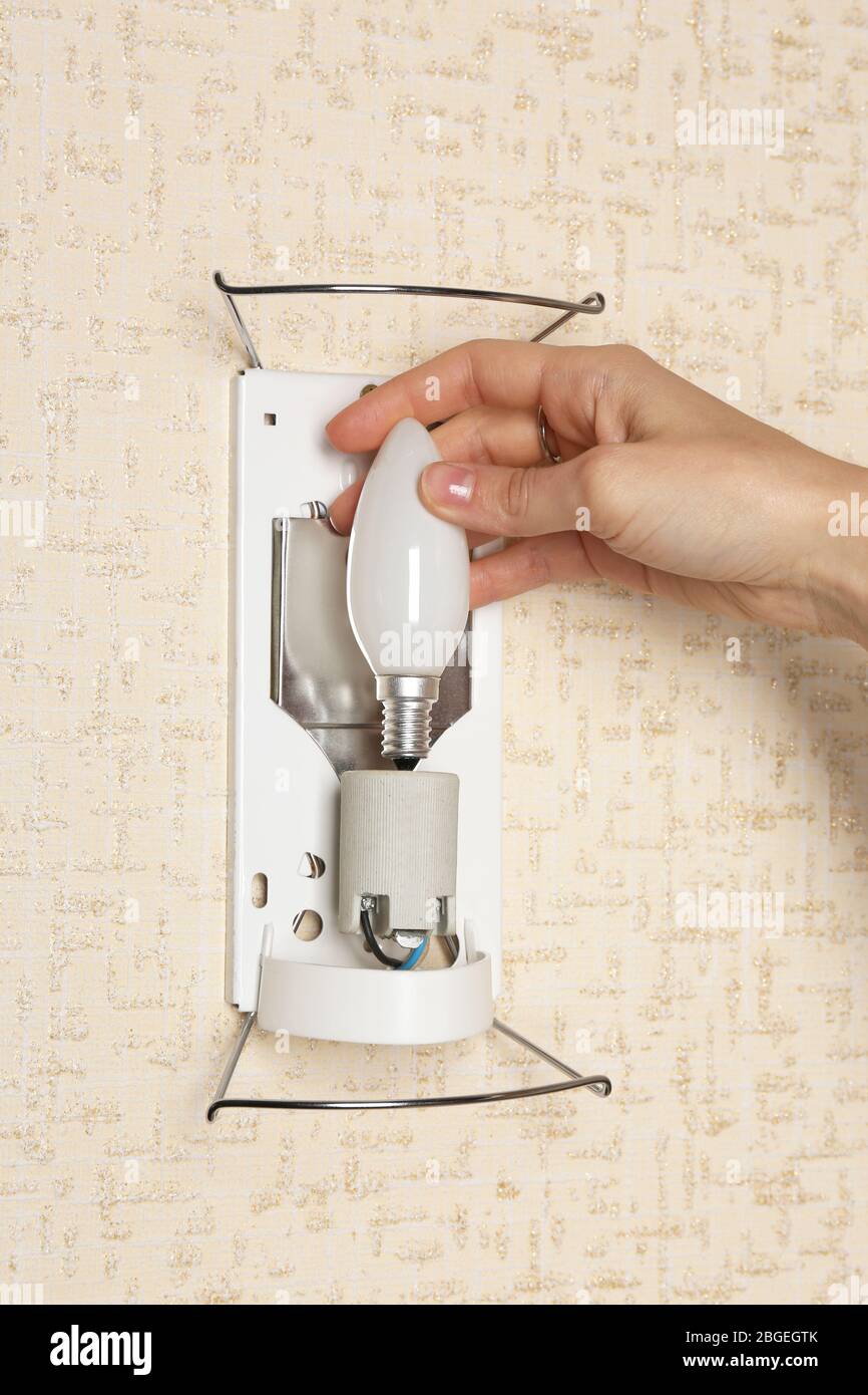 Hand changing light bulb close hi-res stock photography and images - Alamy