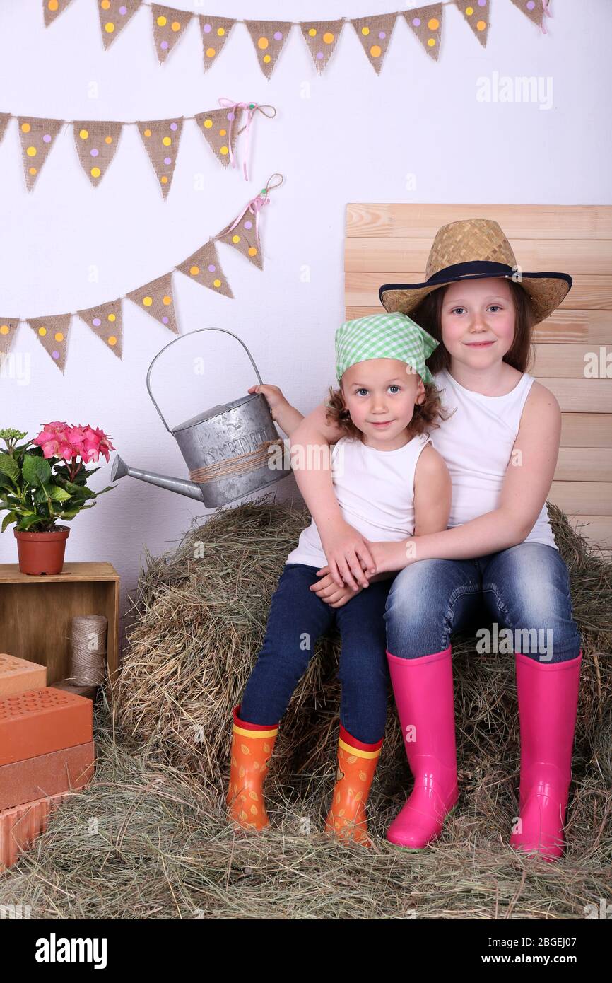Beautiful small girls on country style background Stock Photo - Alamy