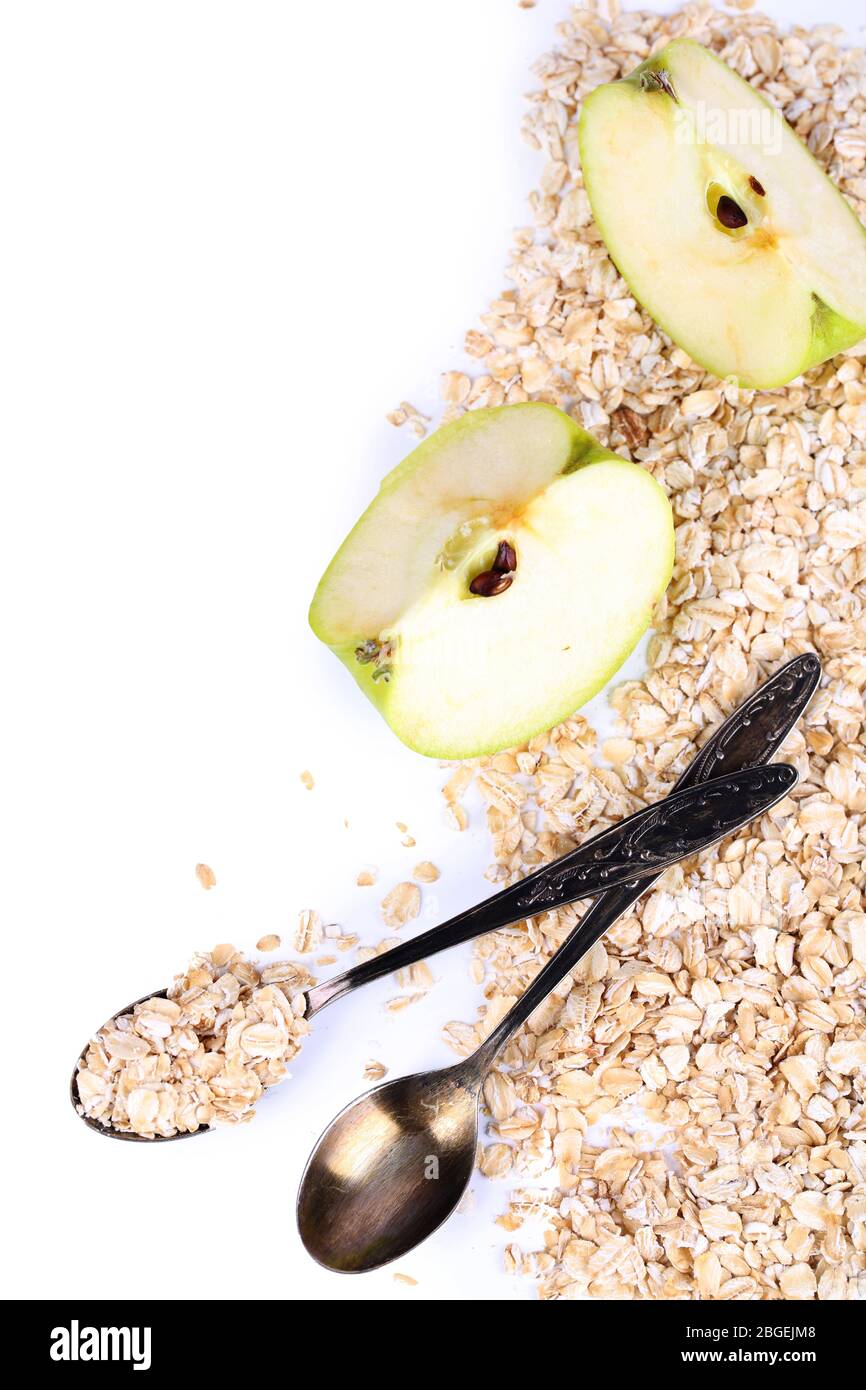Apple with oatmeal and vintage spoons, isolated on white Stock Photo ...