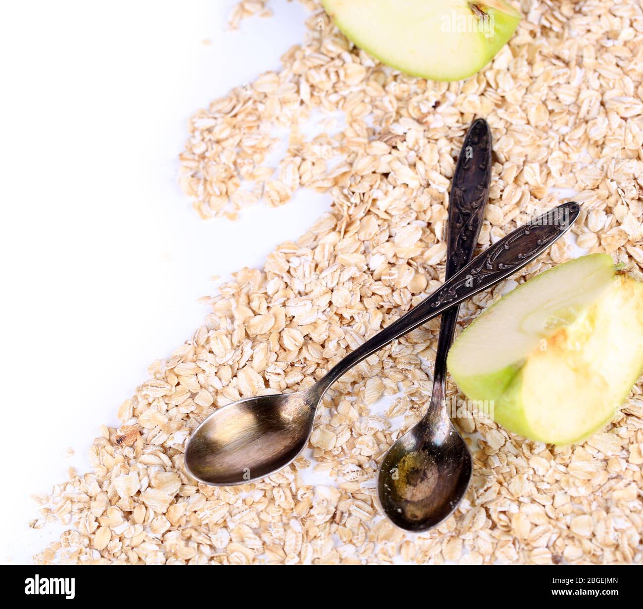 Apple with oatmeal and vintage spoons, isolated on white Stock Photo ...